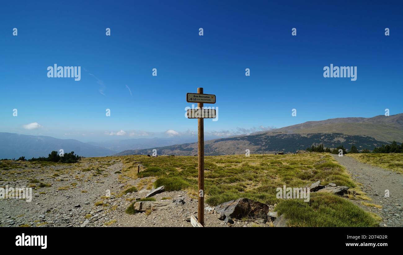 Wooden sign post on a footpath above Hoya del Portillo, Sierra Nevada ...