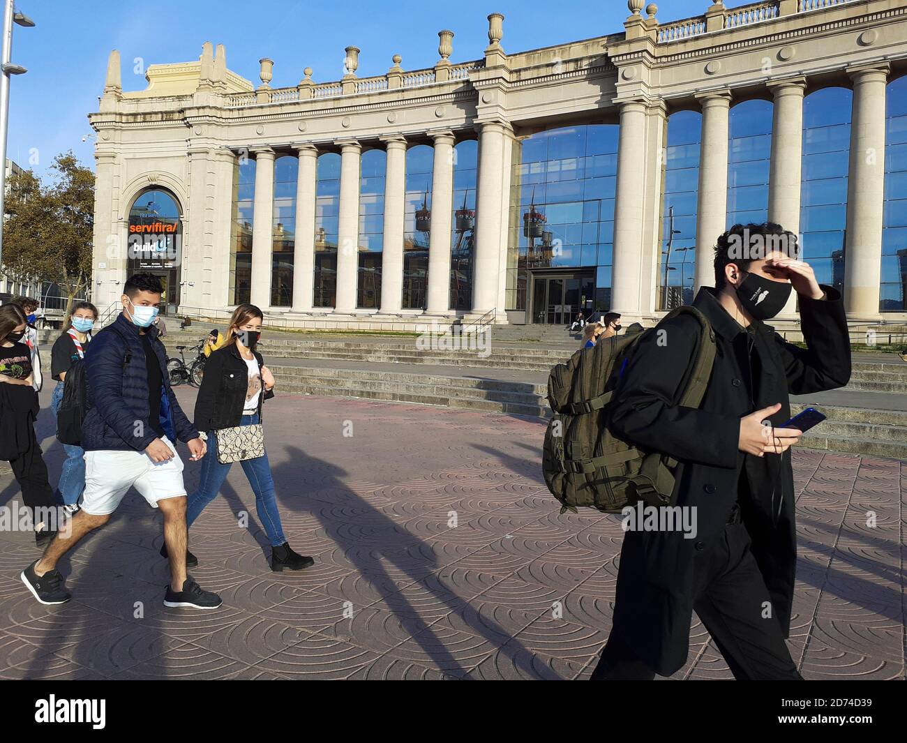 People with mask walking in a square Stock Photo - Alamy