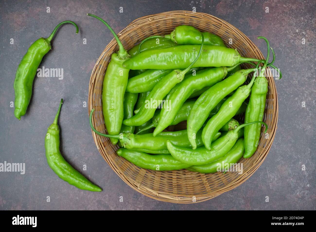 A wicker basket containing fresh small green chilli peppers Stock Photo ...