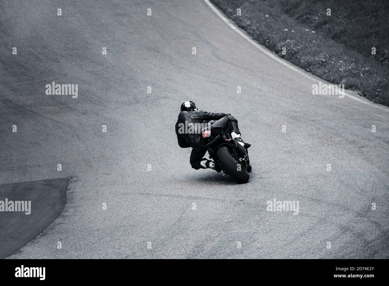 man riding motorcycle in asphalt road. Motorcyclist at black sport ...