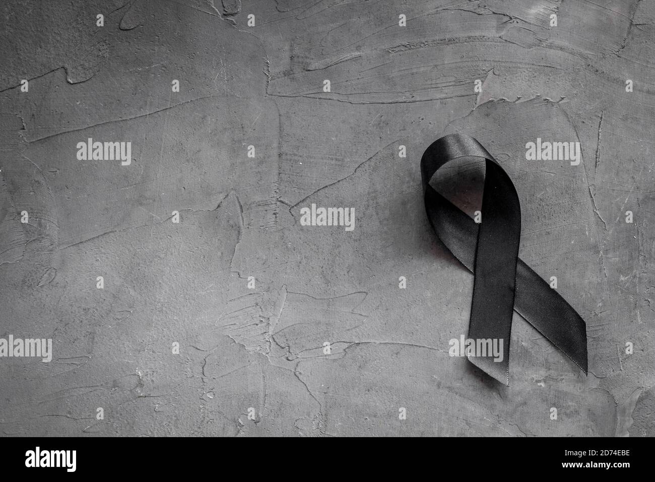 Black awareness ribbon on dark background. Mourning symbol Stock Photo ...