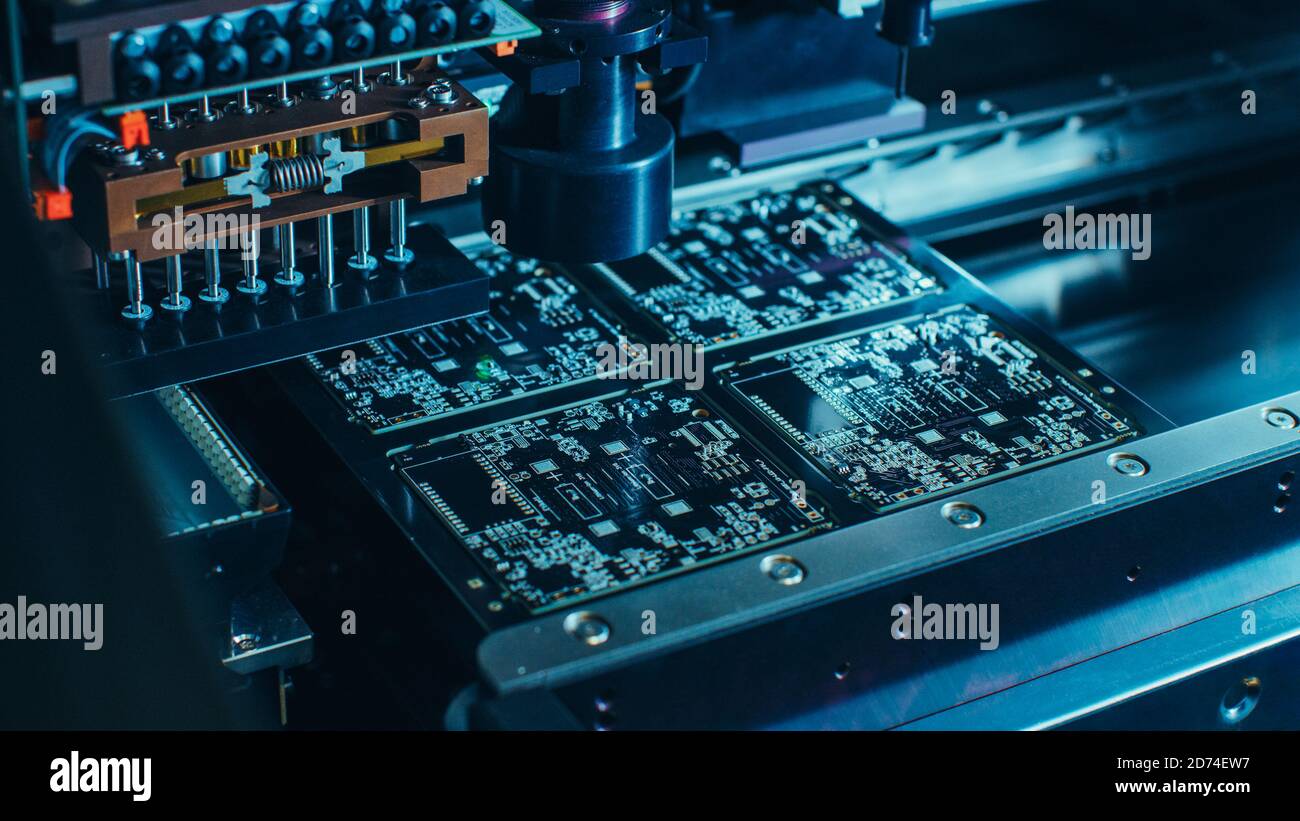 Macro Close Up Shot Of Printed Circuit Board On A Factory Assembly Line With Automated Robotic