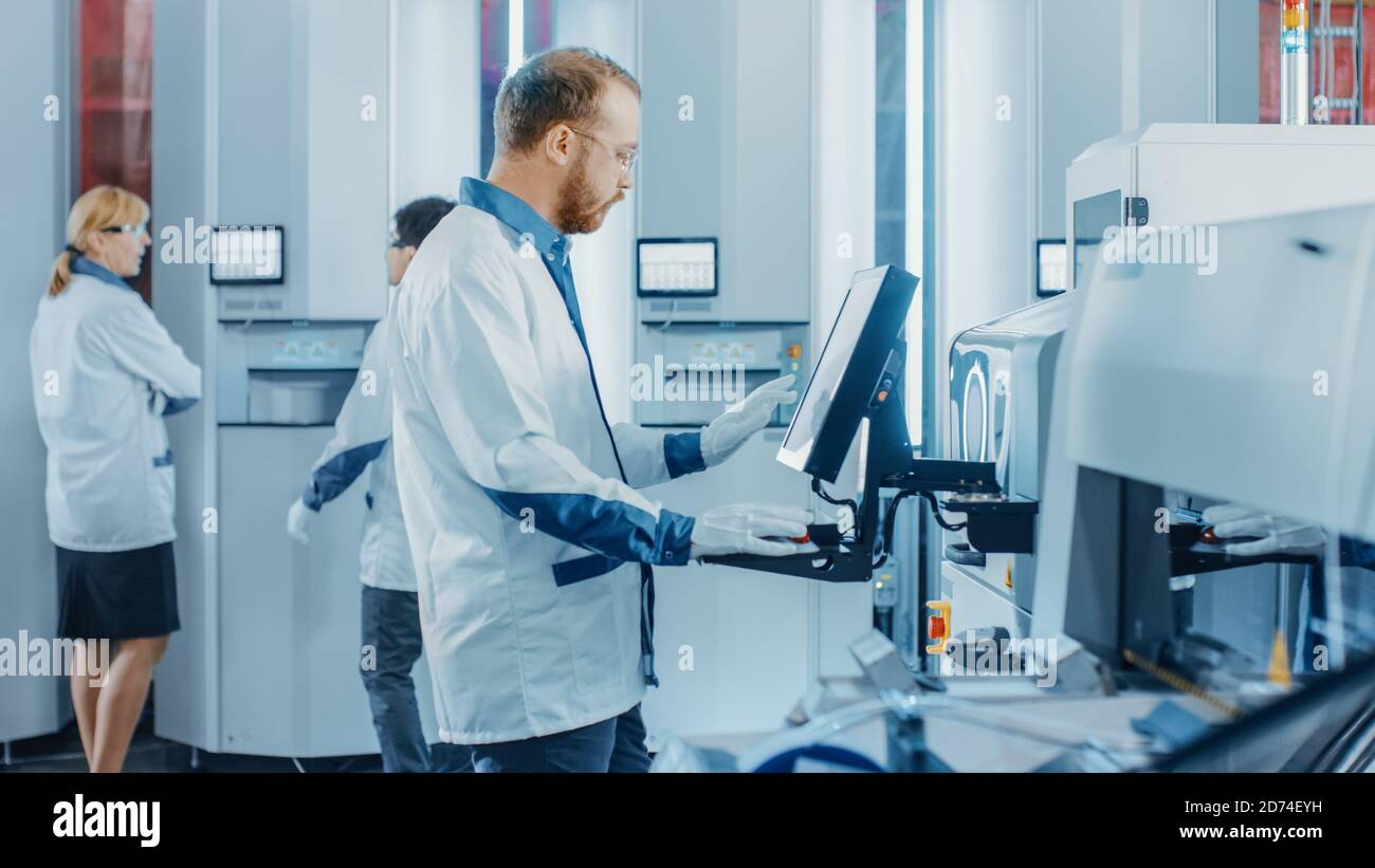 On High Tech Factory Team of Factory Engineers and Workers Use ...