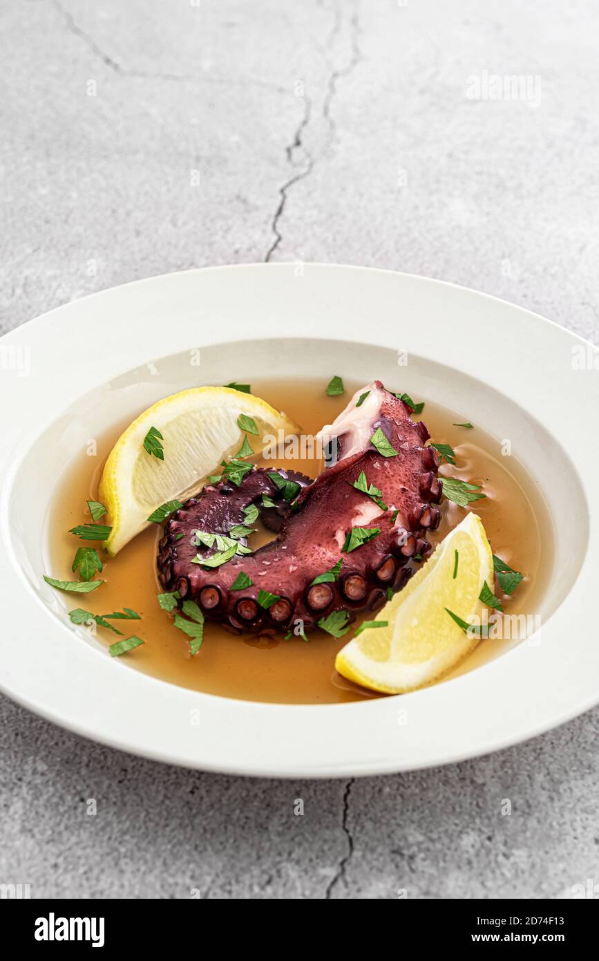 Octopus Stew with lemons and herbs Stock Photo - Alamy