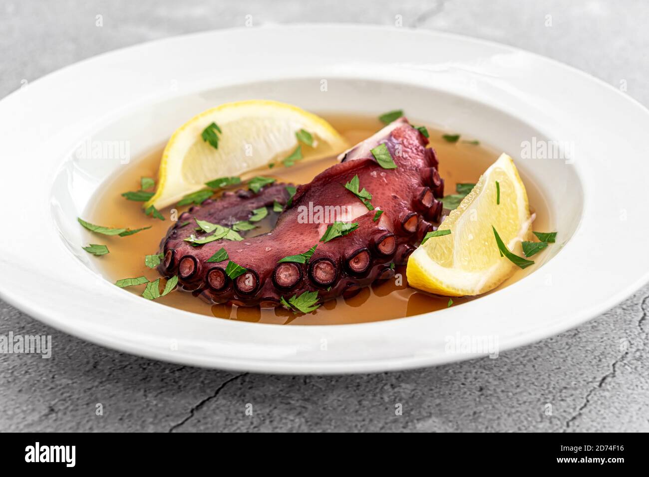 Octopus Stew with lemons and herbs Stock Photo - Alamy