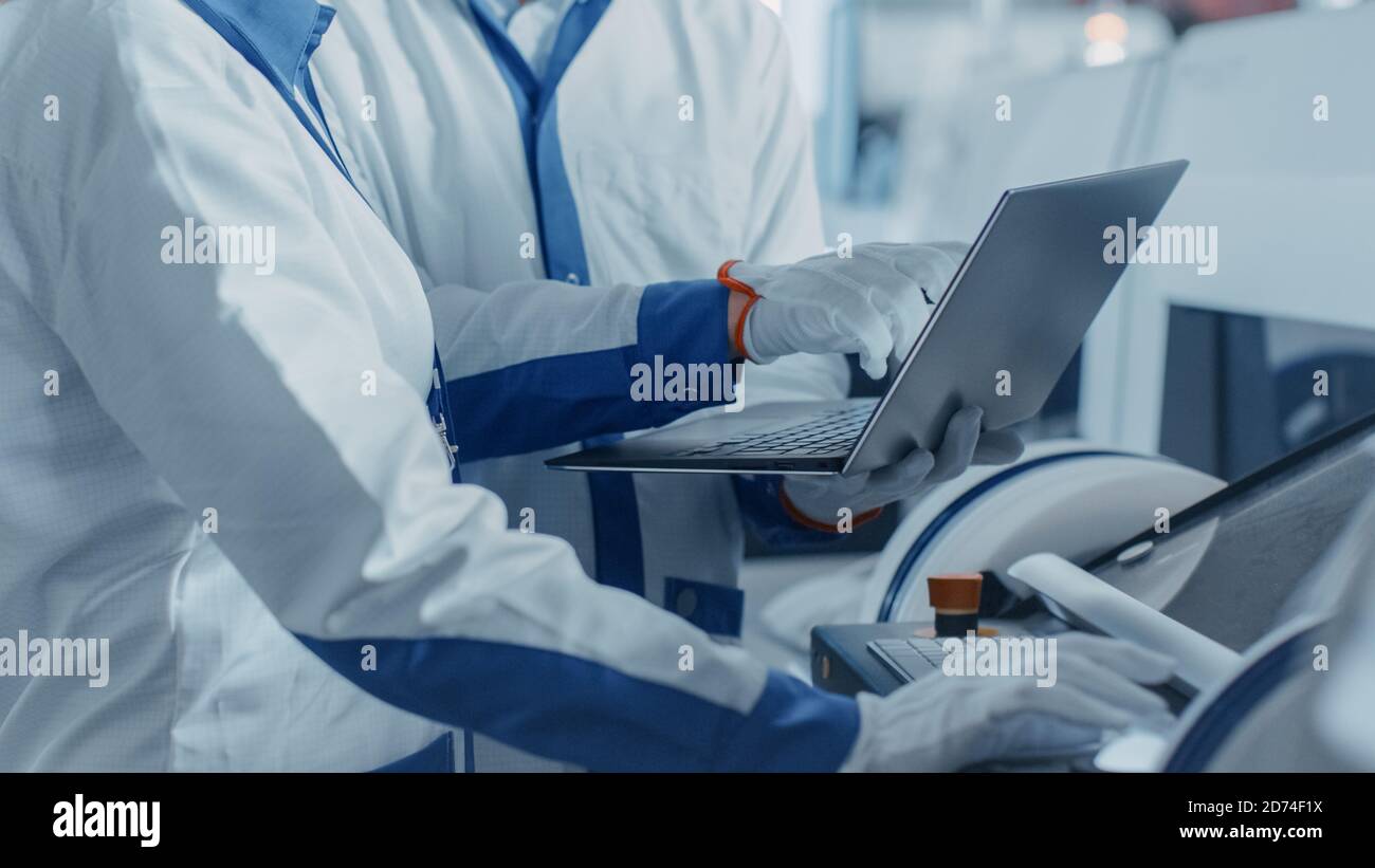 Close-up Shot of an Engineers Hands On High Tech Factory Using Computer ...