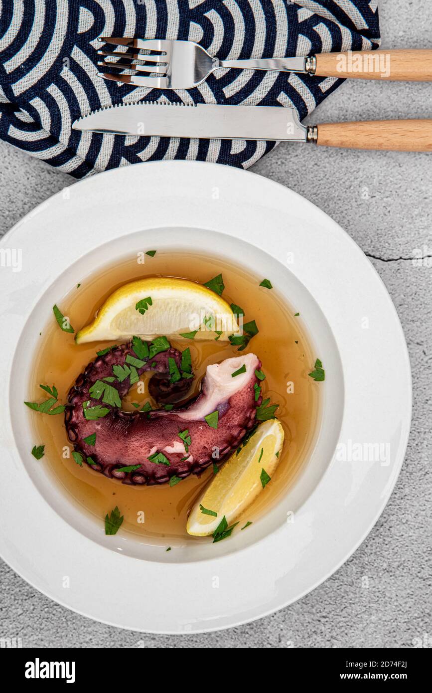 Octopus Stew with lemons and herbs Stock Photo - Alamy