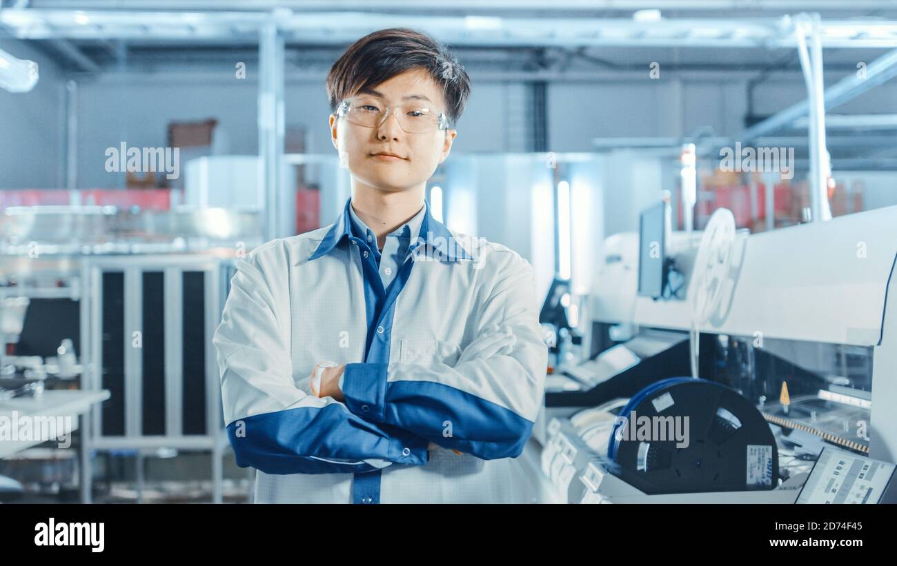 On High-Tech Factory: Portrait of Asian Worker with Crossed Arms. In ...