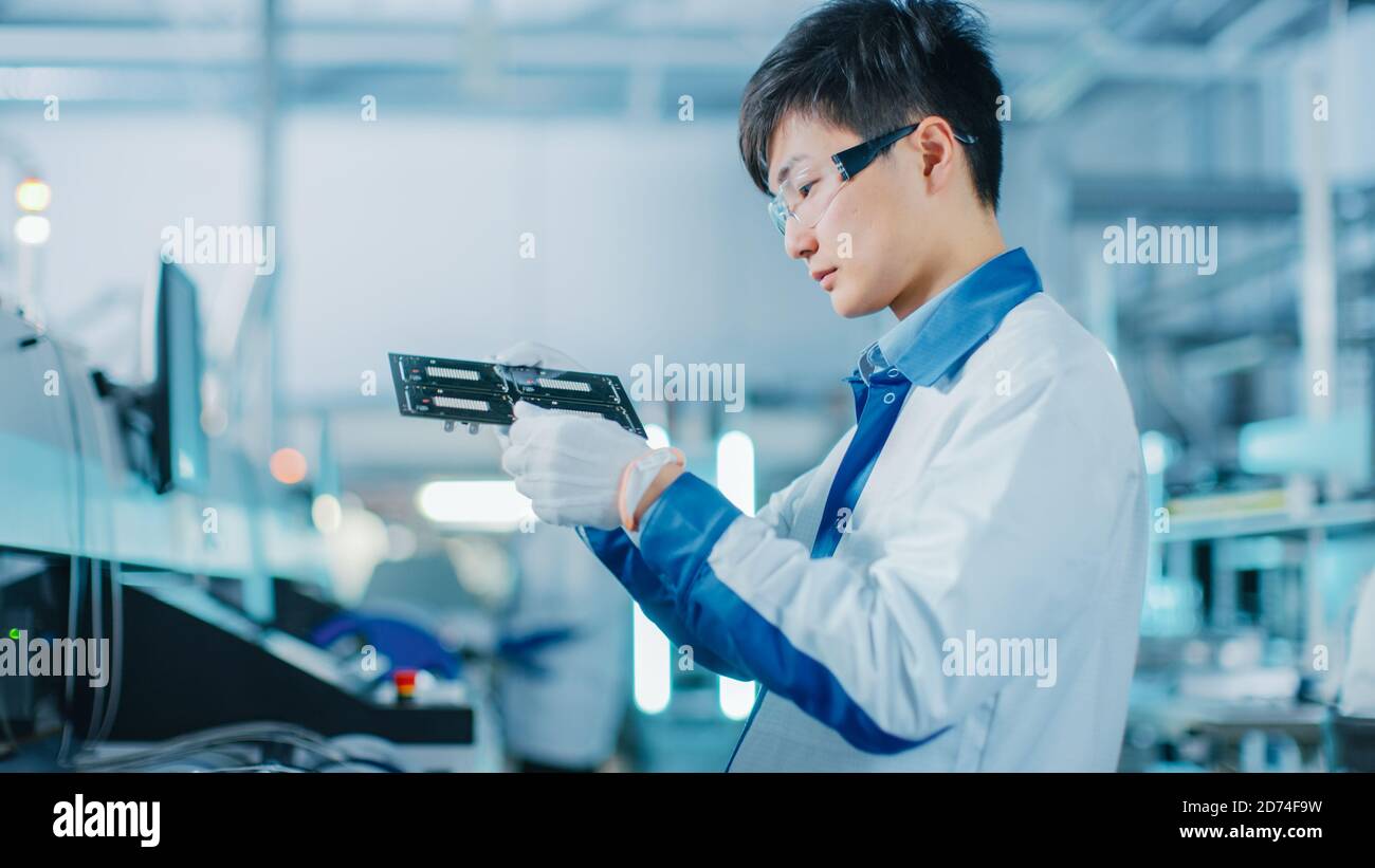 Worker checks electronic device hi-res stock photography and images - Alamy