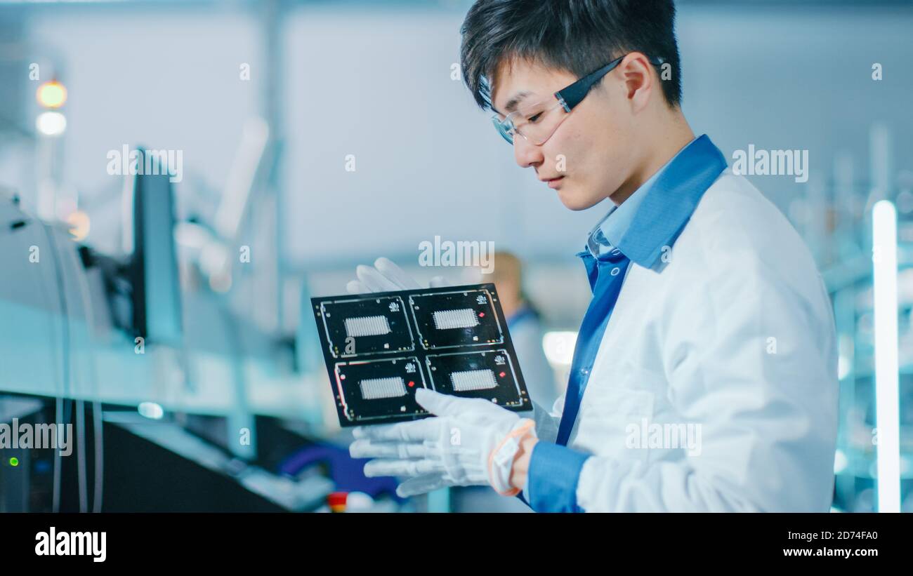 High-Tech Factory: Quality Control Engineer Checks Electronic Printed ...