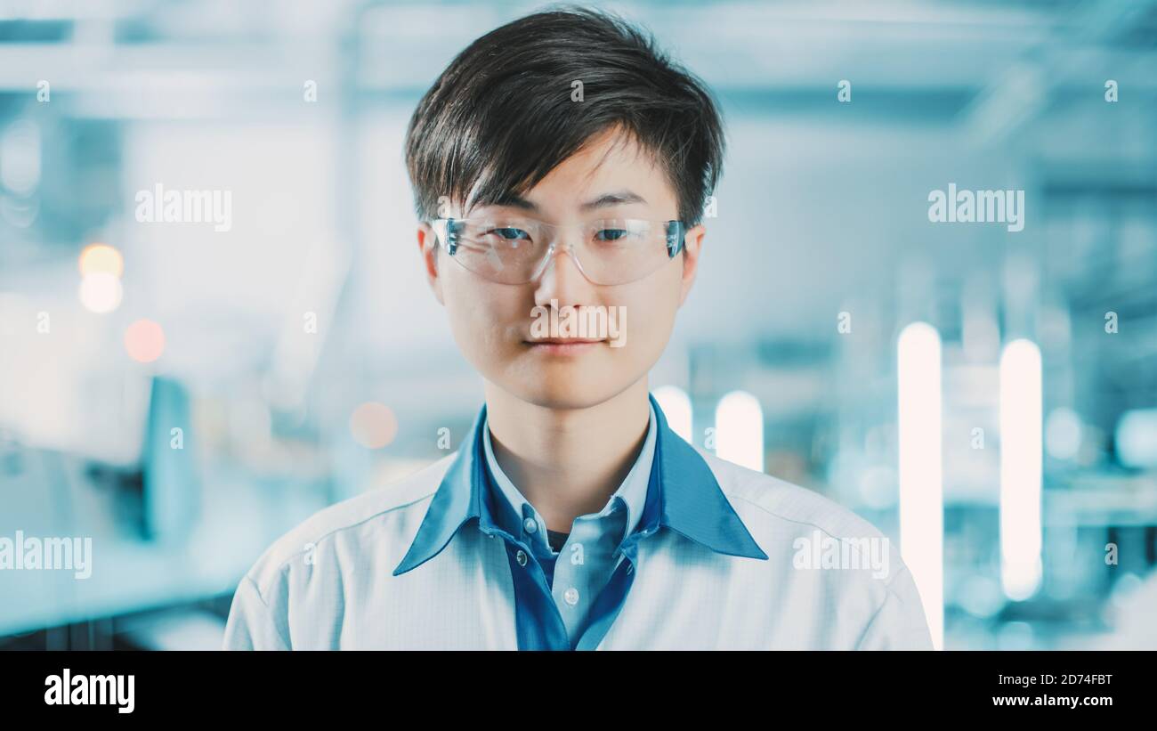 On High-Tech Factory: Portrait of Asian Worker Wearing Uniform and ...