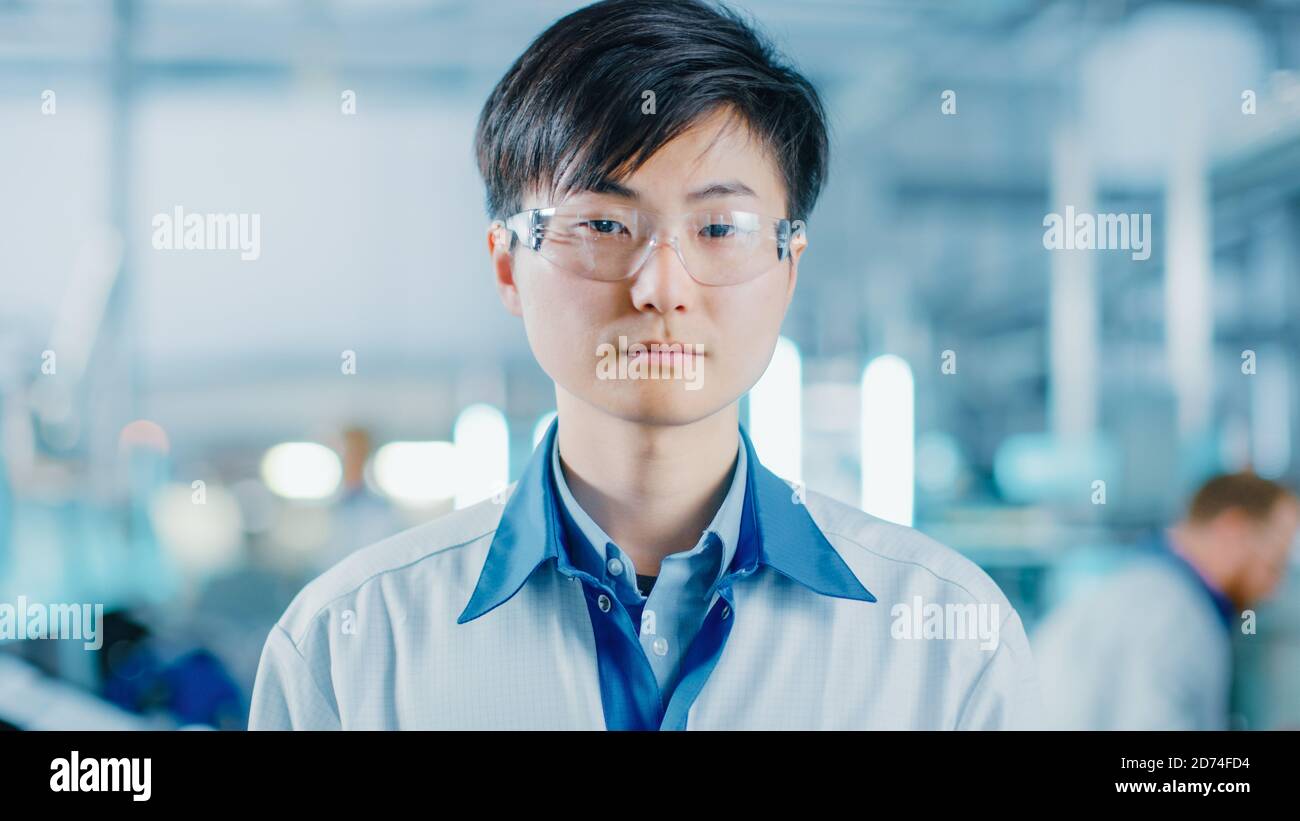 On High-Tech Factory: Portrait of Asian Worker Wearing Uniform and ...