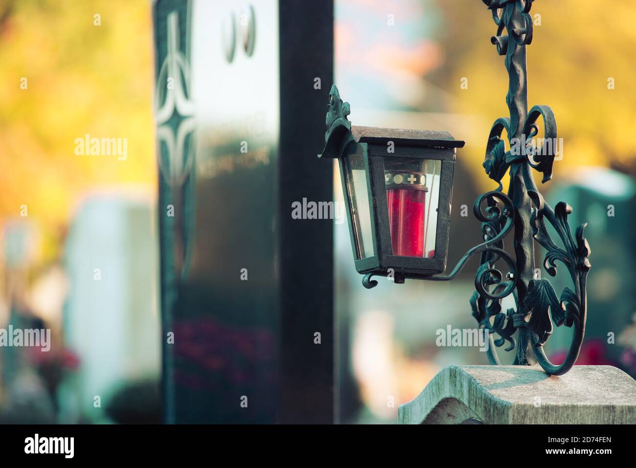 Candle in an iron lantern on a grave at a cemetery Stock Photo - Alamy