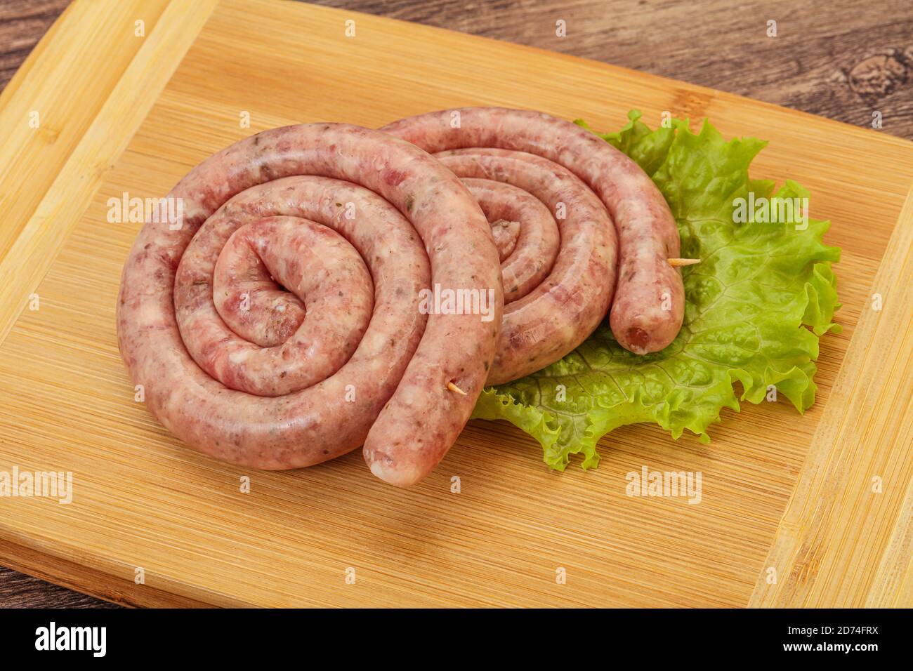 Raw pork sausage ring for grill Stock Photo - Alamy