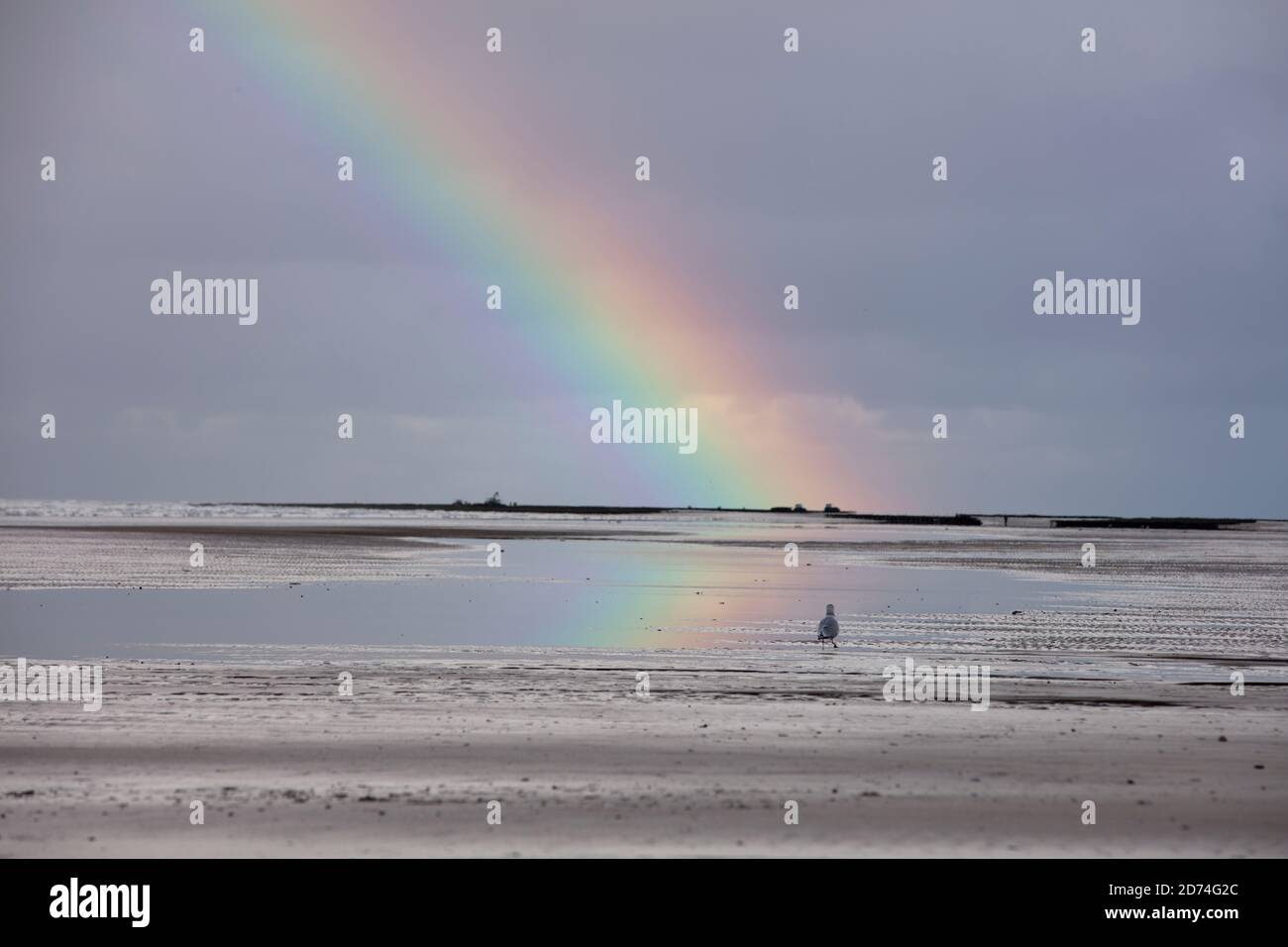 Rainbow between dark clouds hi-res stock photography and images - Alamy