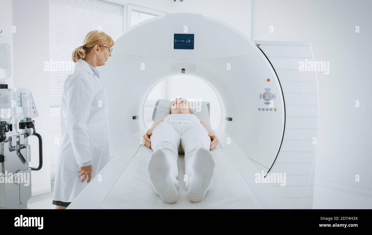 In Medical Laboratory Female Radiologist Controls MRI or CT Scan with ...
