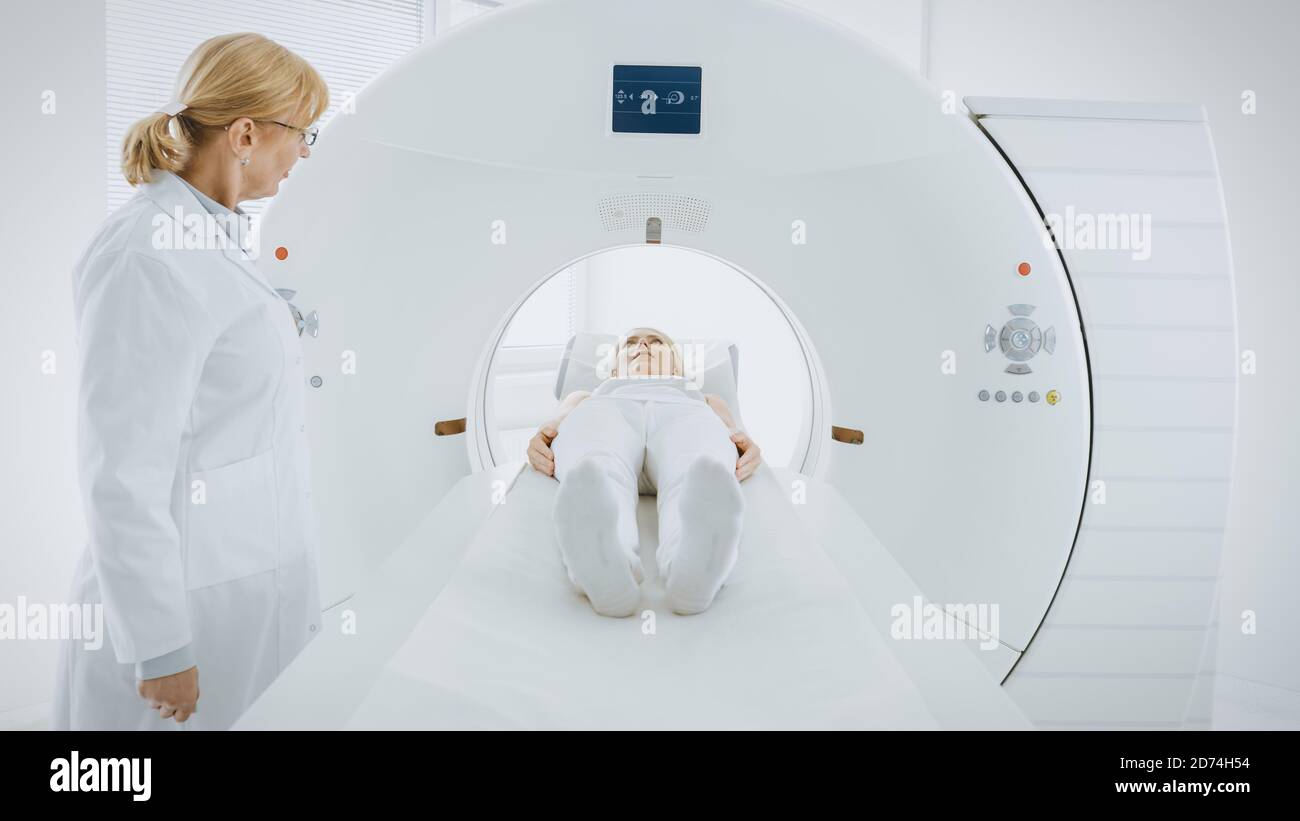 In Medical Laboratory Female Radiologist Controls MRI or CT or PET Scan ...
