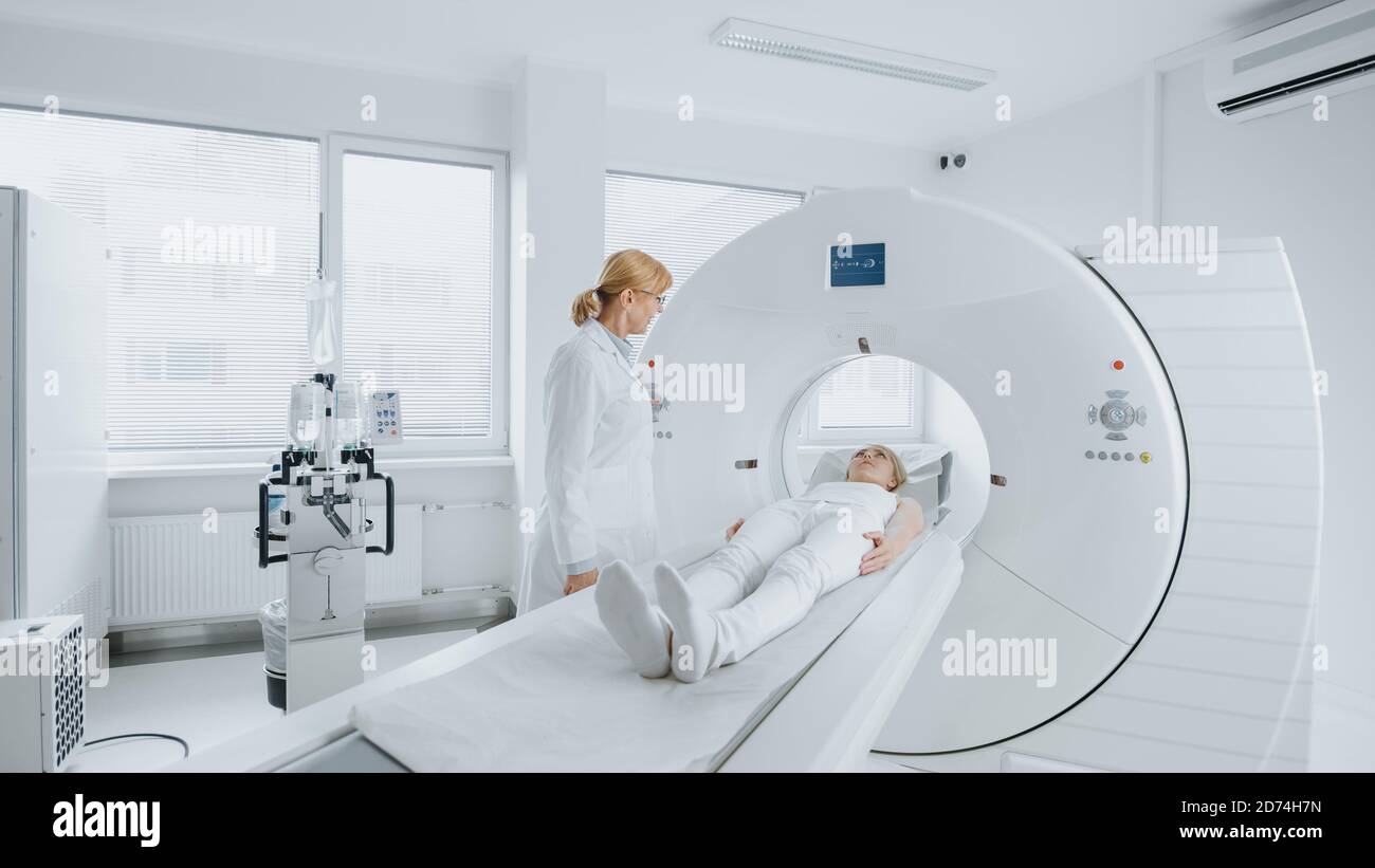 In Medical Laboratory Female Radiologist Controls MRI or CT Scan with ...