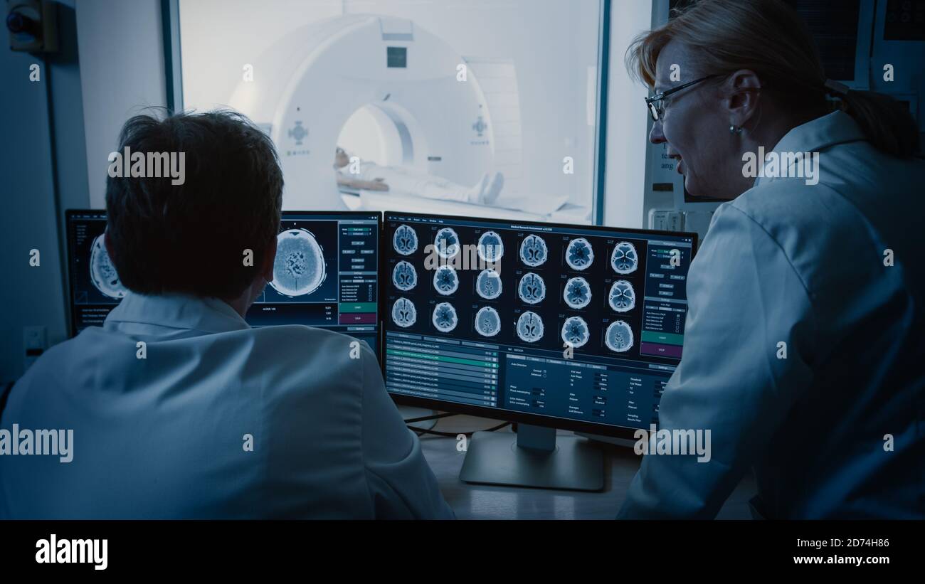 In Control Room Doctor and Radiologist Discuss Diagnosis while Watching ...