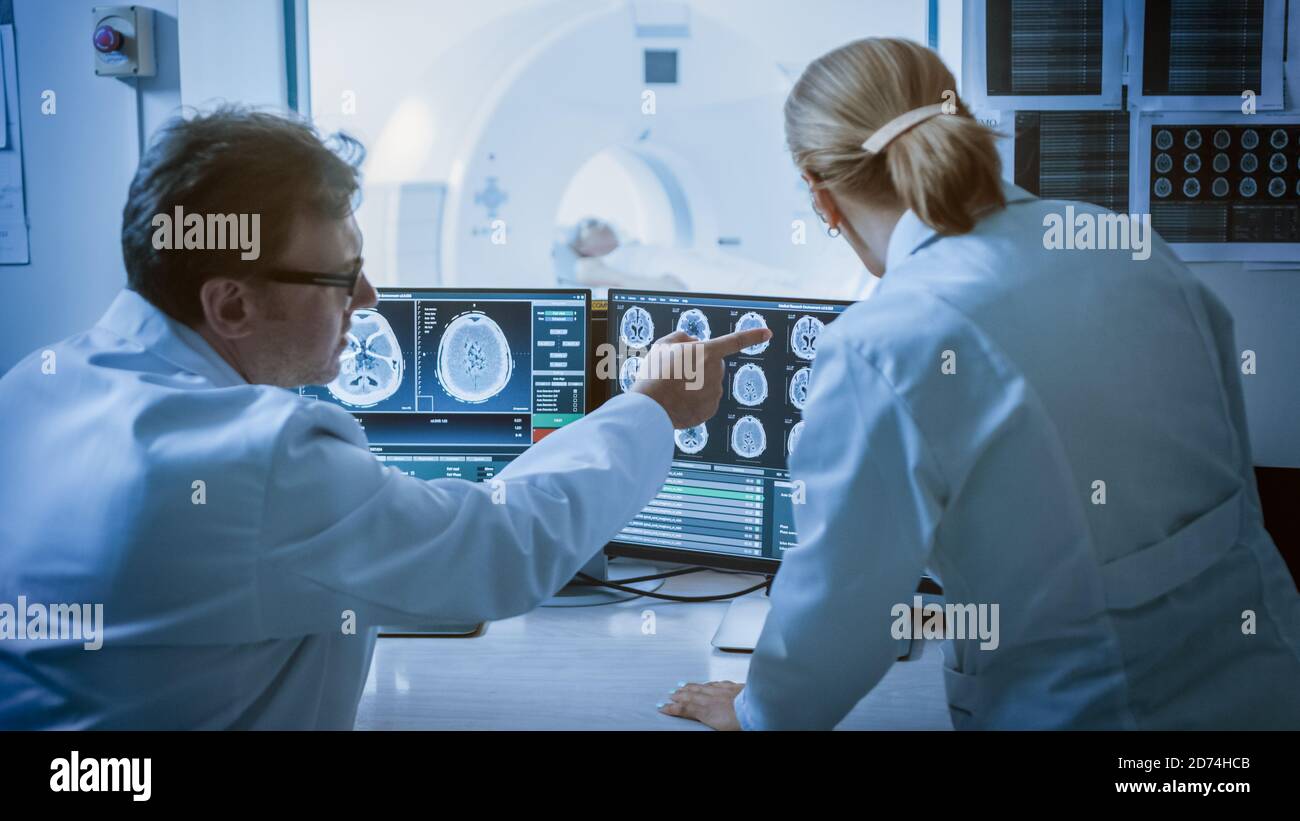 In Control Room Doctor and Radiologist Discuss Diagnosis while Watching ...