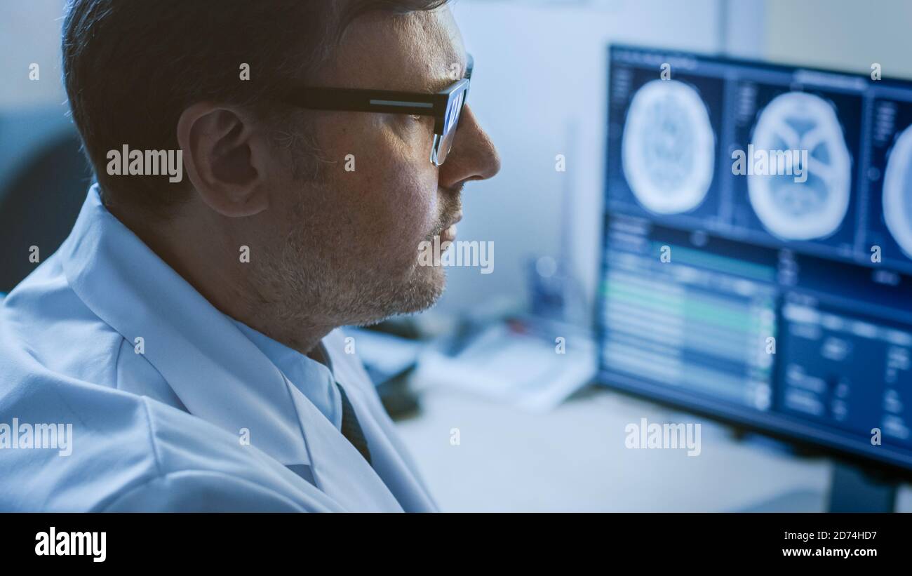 Doctor looking computer screen examination room hi-res stock ...