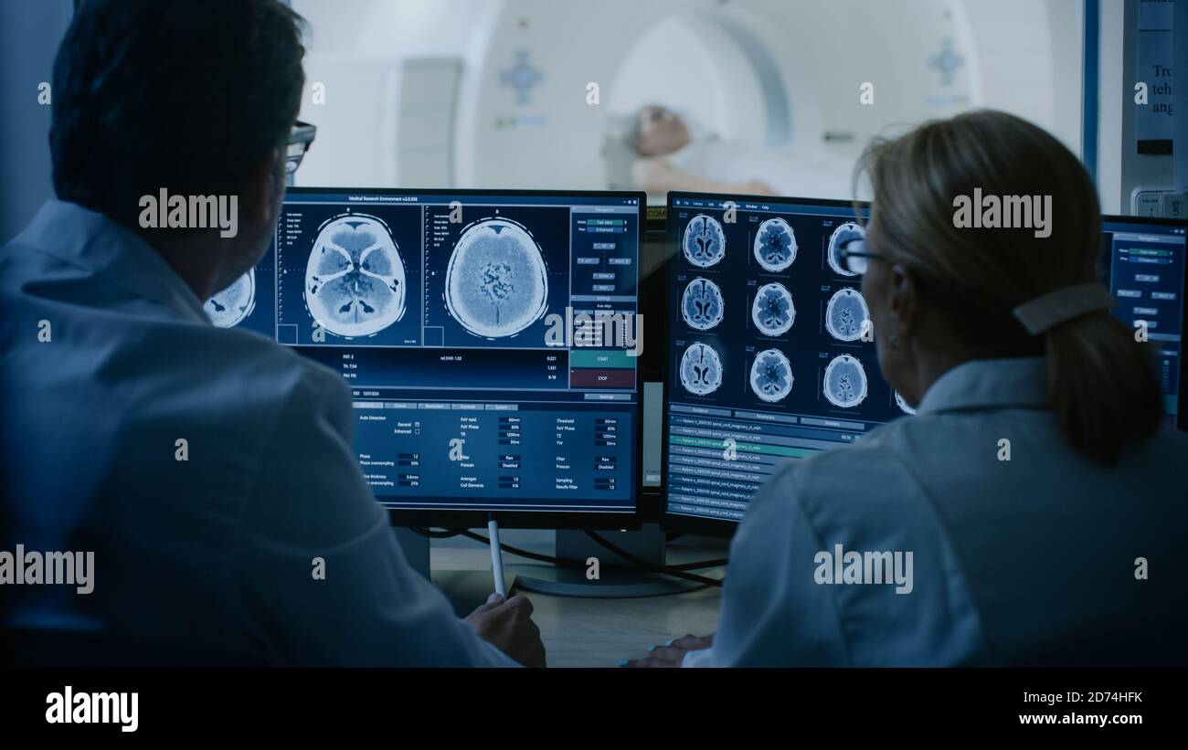 In Control Room Doctor and Radiologist Discuss Diagnosis while Watching ...