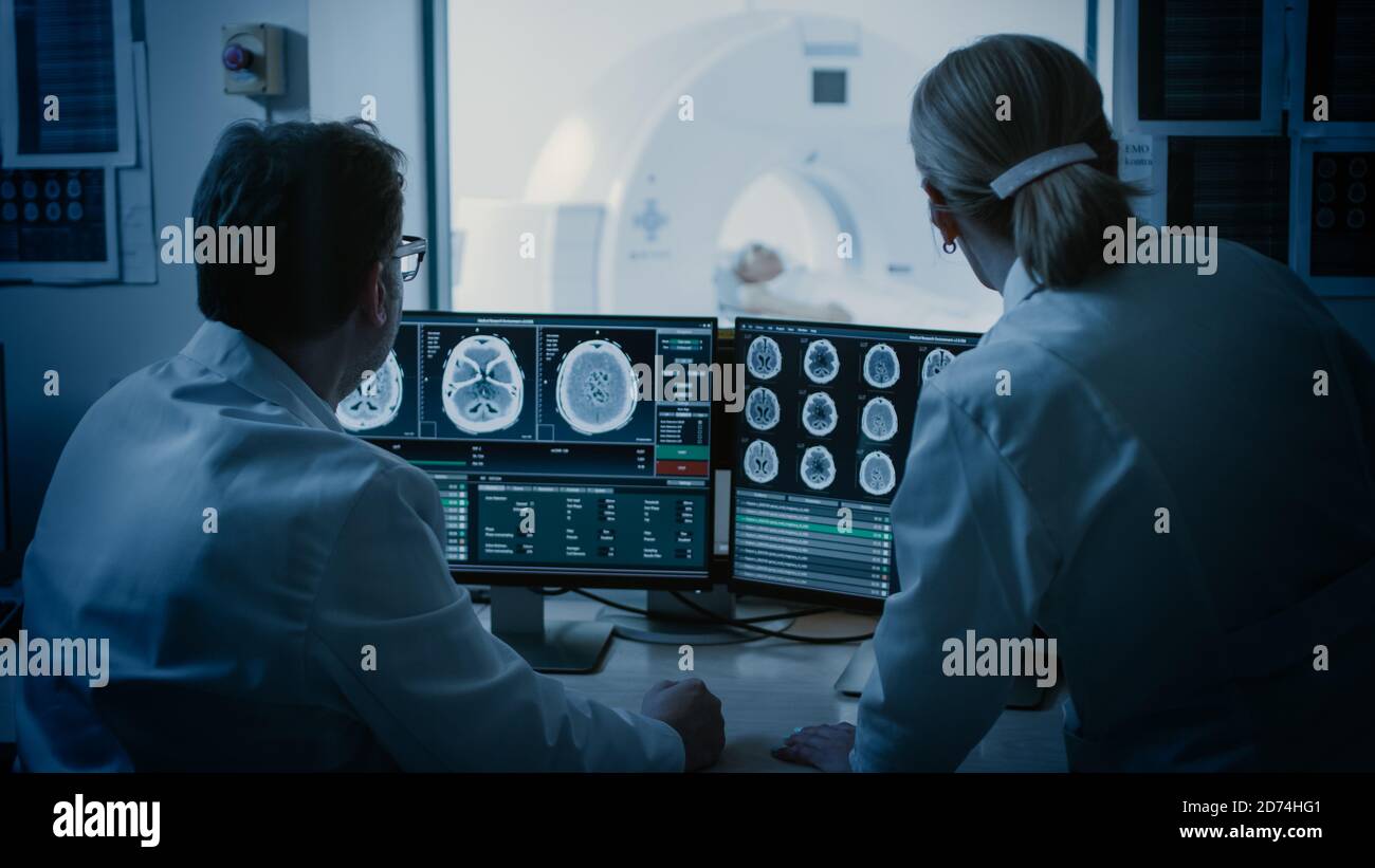 In Control Room Doctor and Radiologist Discuss Diagnosis while Watching ...