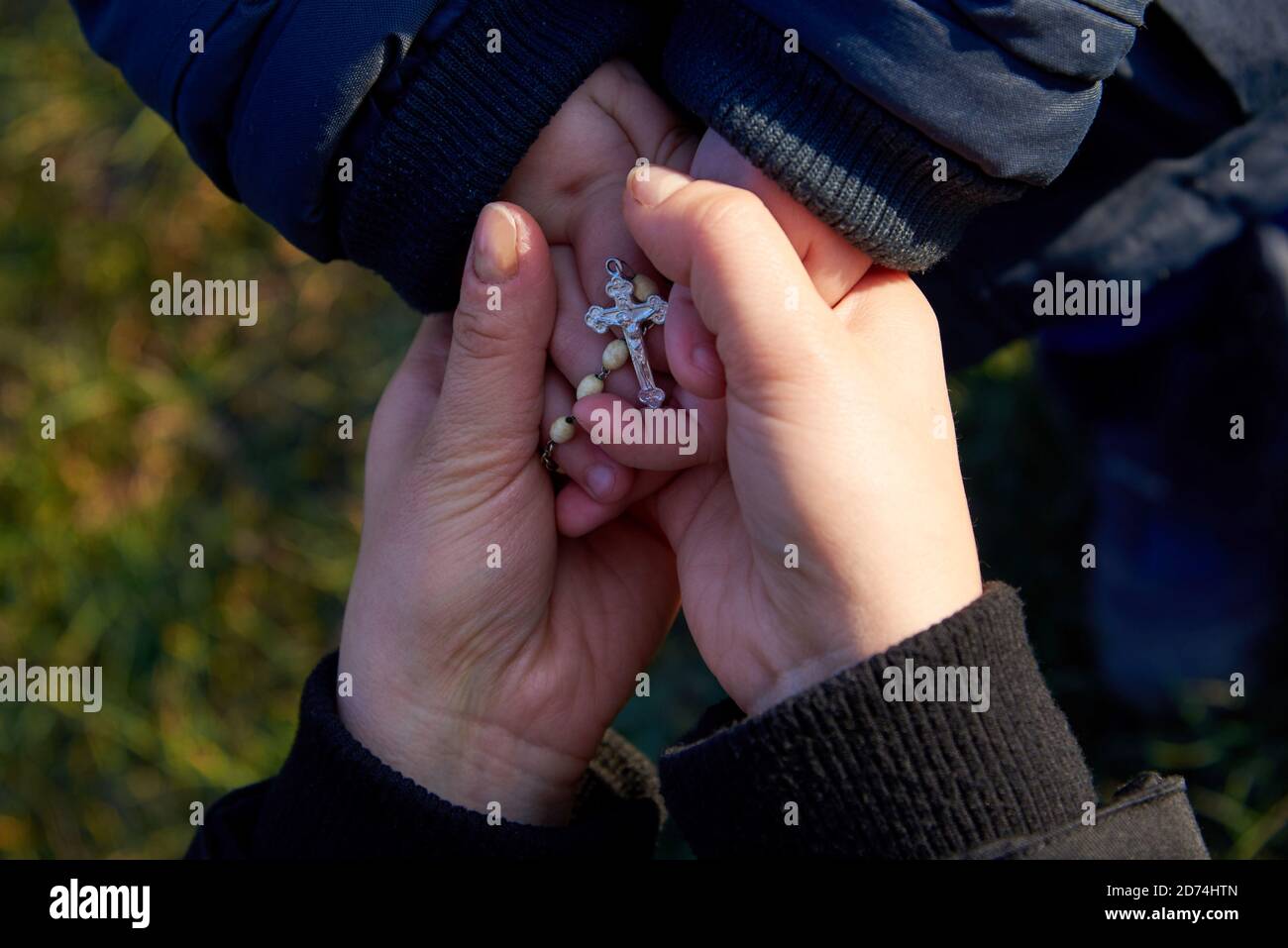 Mother and little son hold each other's hand with a rosary, Christian ...