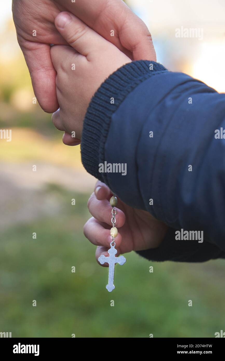 Dad and little son hold each other's hand with a rosary, Christian ...
