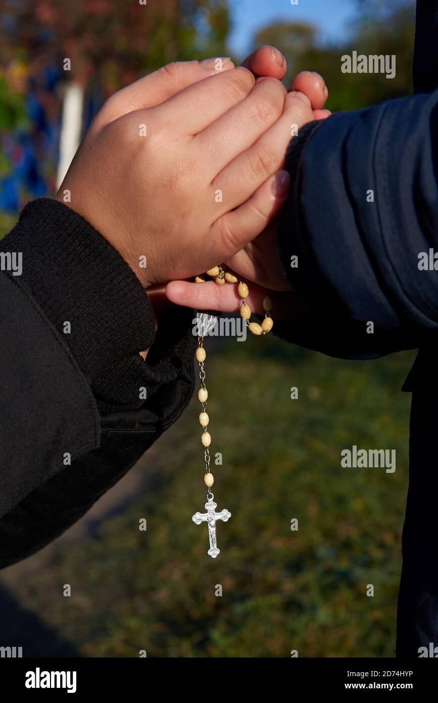 Mother and little son hold each other's hand with a rosary, Christian ...