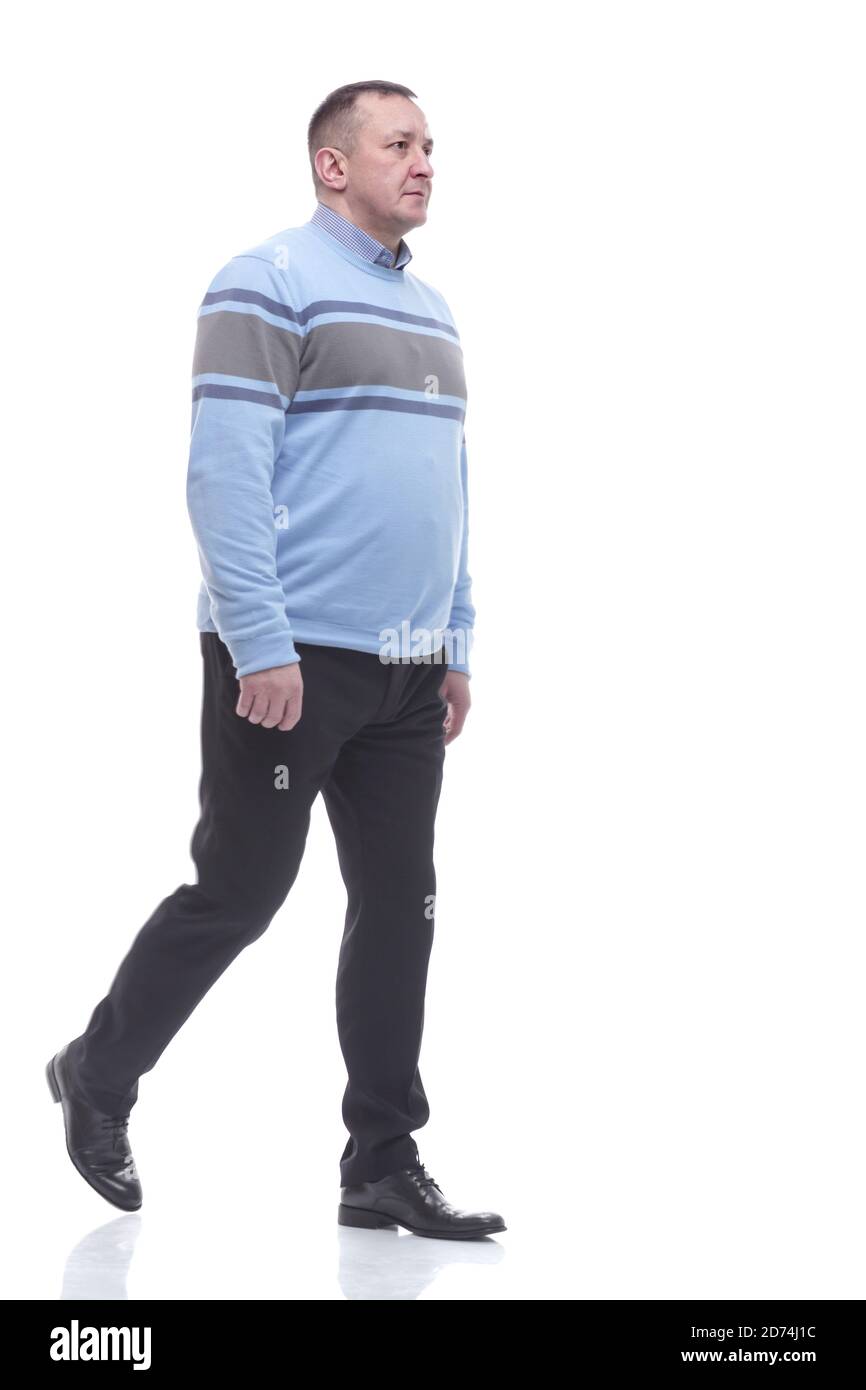 side view. a serious man in a sweater walks forward Stock Photo - Alamy