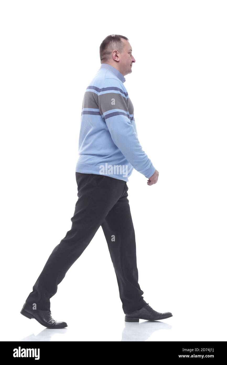 side view. a serious man in a sweater walks forward Stock Photo - Alamy