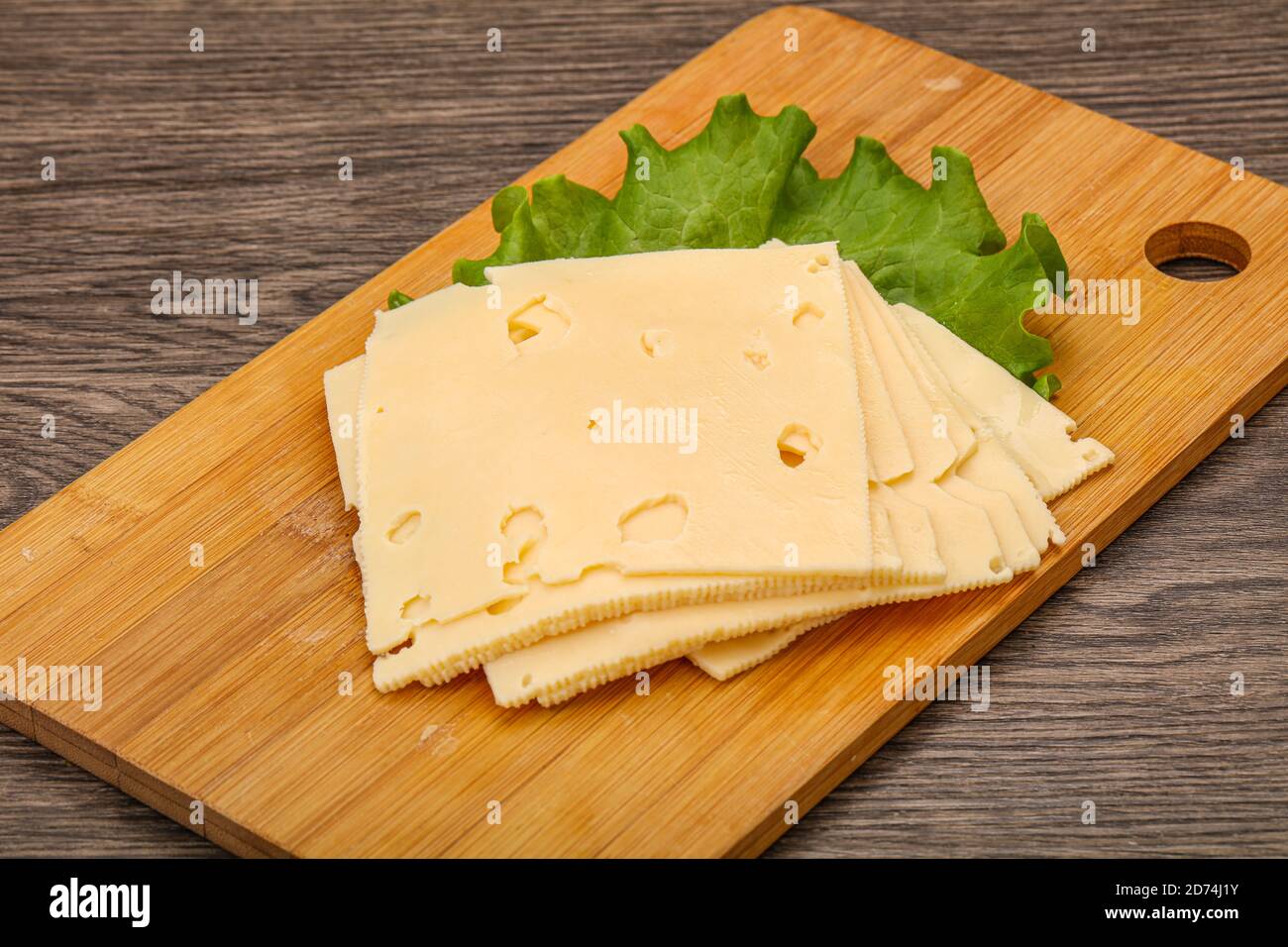 Sliced yellow cheese over salad leaves Stock Photo - Alamy