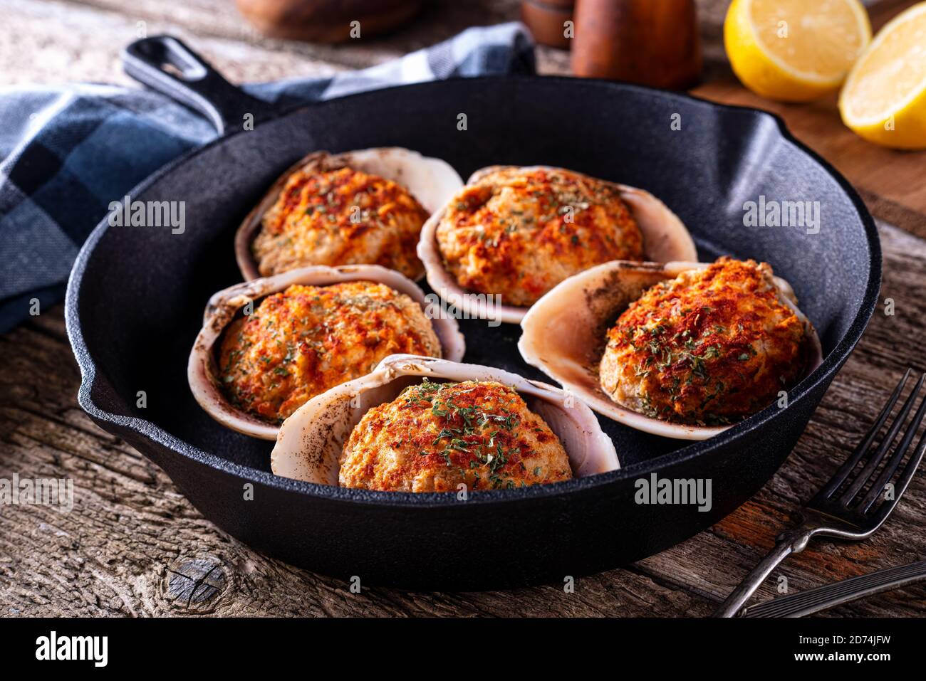 Delicious oven baked stuffed clams on a rustic wood table top Stock ...