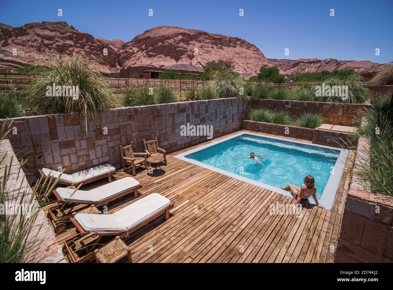 Couple at a private swimming pool at Hotel Alto Atacama Desert Lodge ...