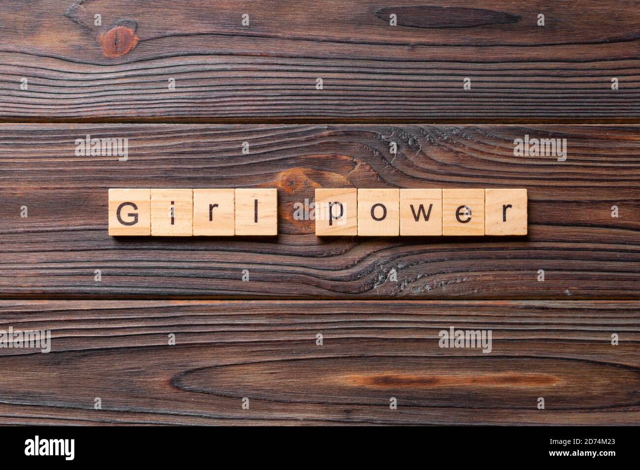 Girl Power word written on wood block. Girl Power text on cement table ...