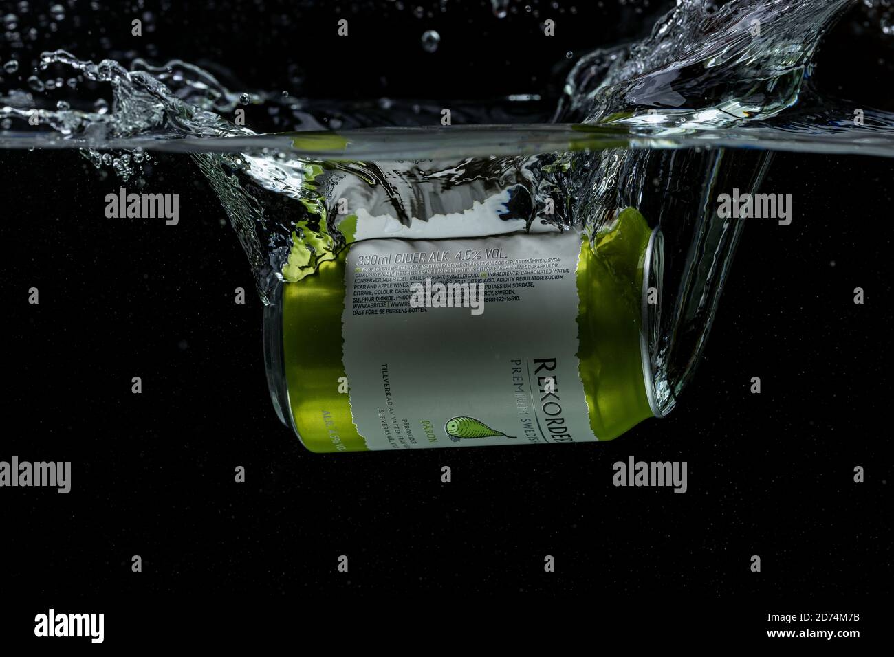 Close up view of can falling in water. Pear sider Stock Photo - Alamy