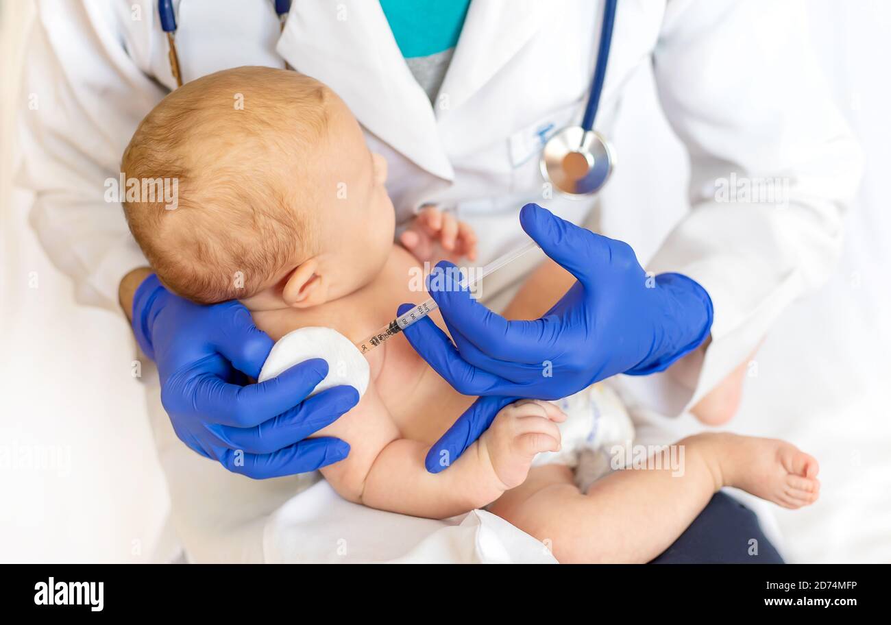 Vaccination baby, injection in the arm. Selective focus. People Stock ...