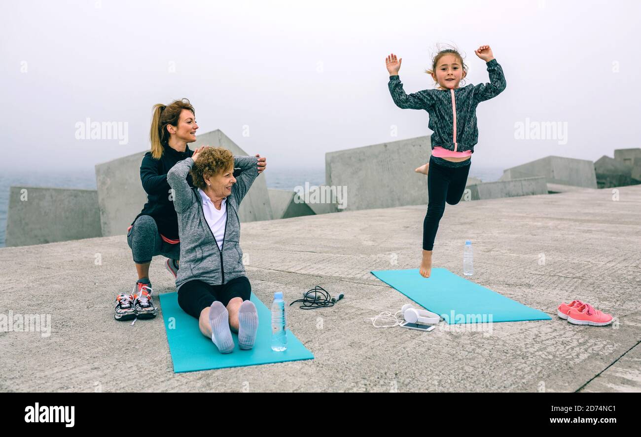 Girl jumping while women train Stock Photo - Alamy