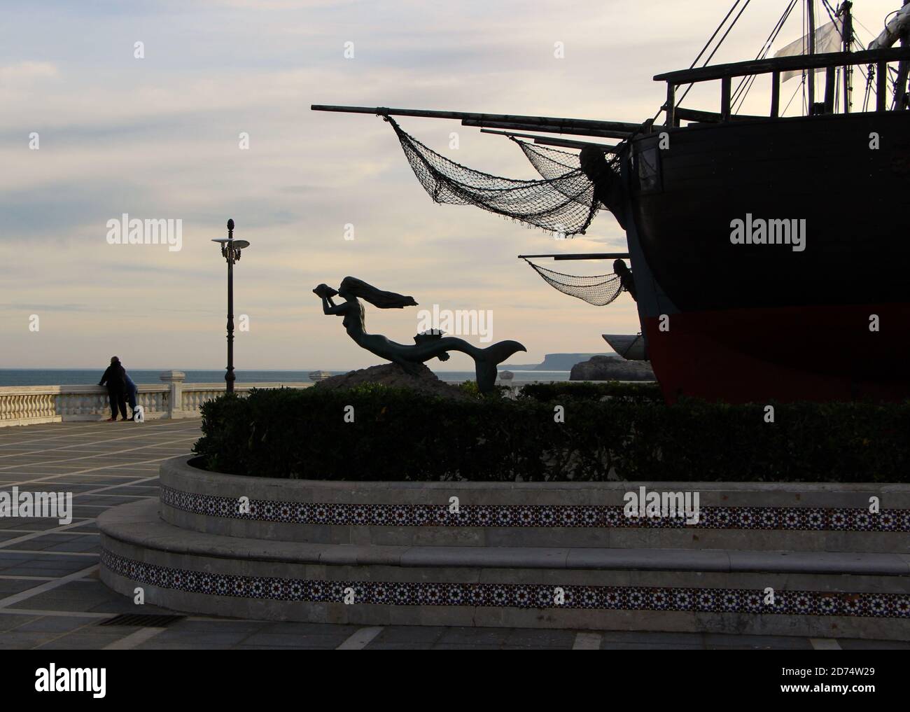 Mermaid sculpture in front of three replica ships which were sailed ...