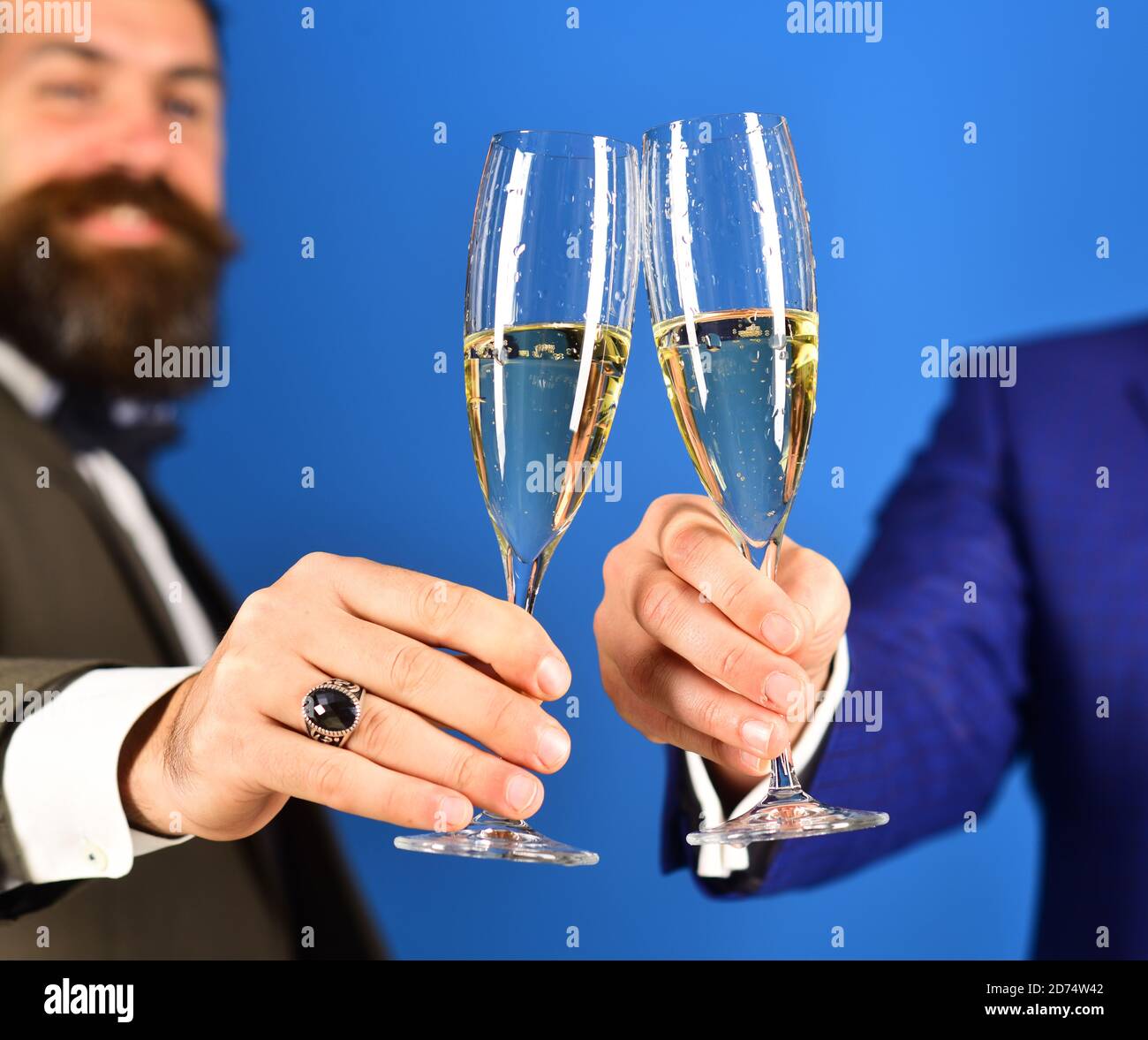 Christmas corporate party concept. Managers with beards hold glasses of ...