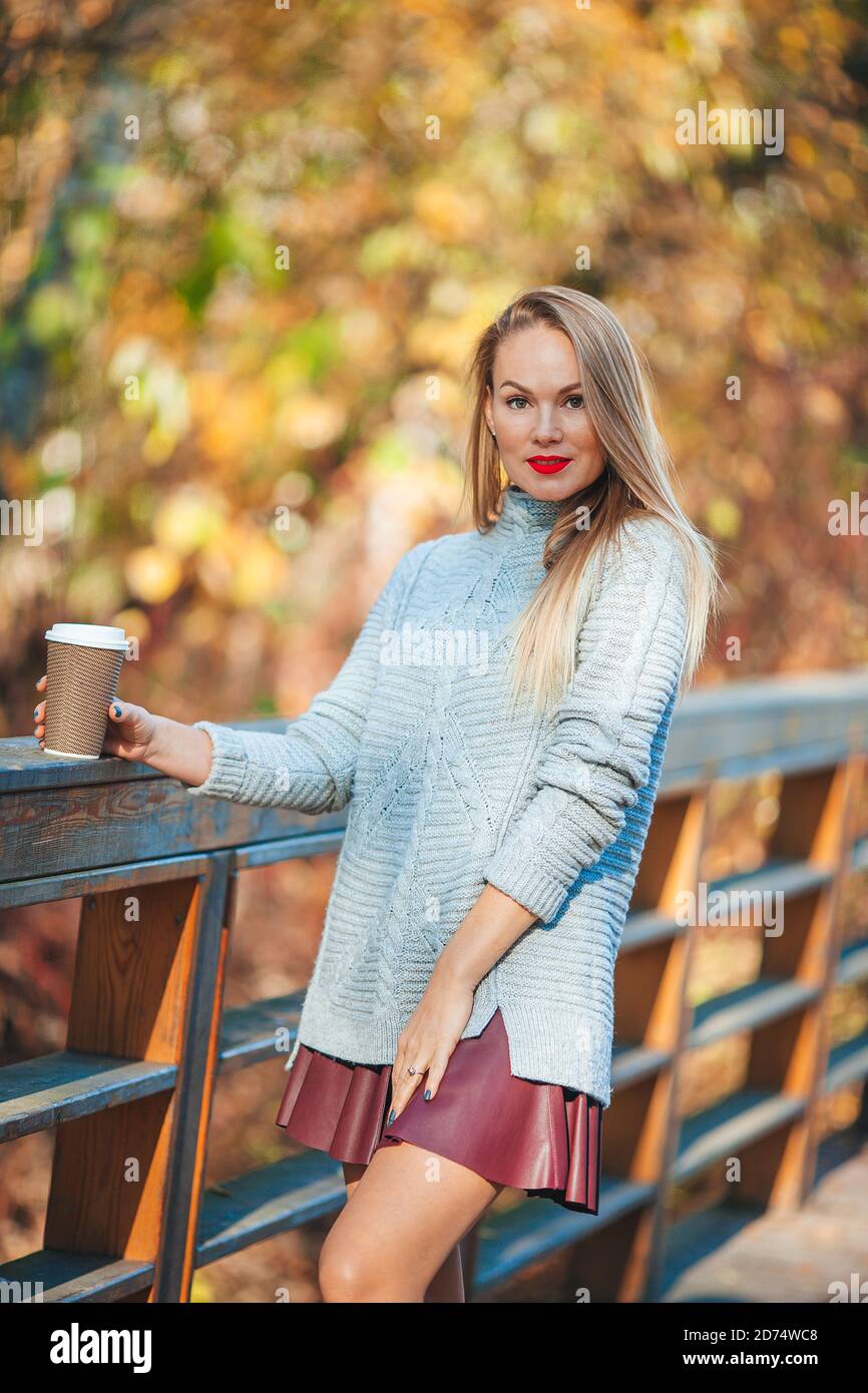 Beautiful woman in autumn park under fall foliage Stock Photo - Alamy
