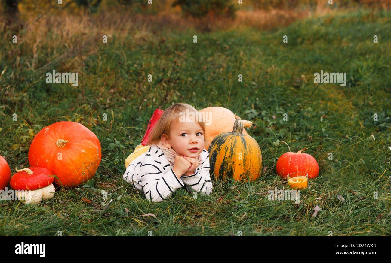 A brooding little child rests on his arms and looks into the distance ...