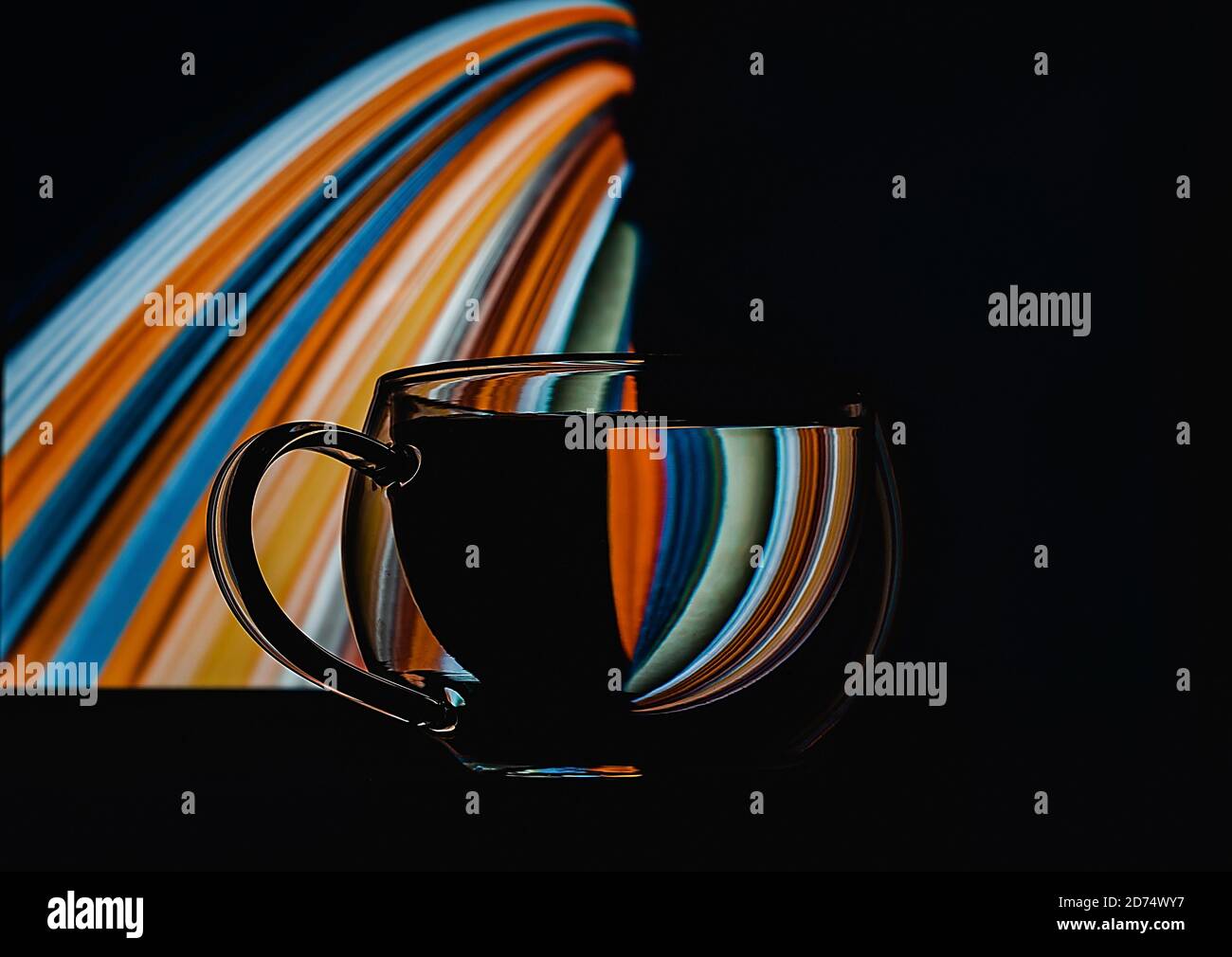 Abstract colorful refraction in transparent glass of water on isoleted ...