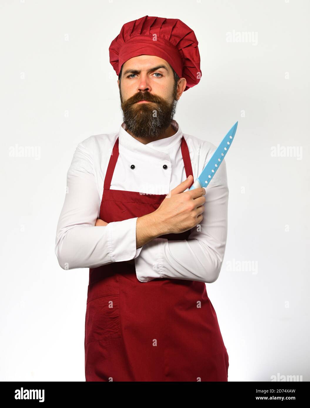Cook with proud face in burgundy apron and chef hat. Cooking and ...