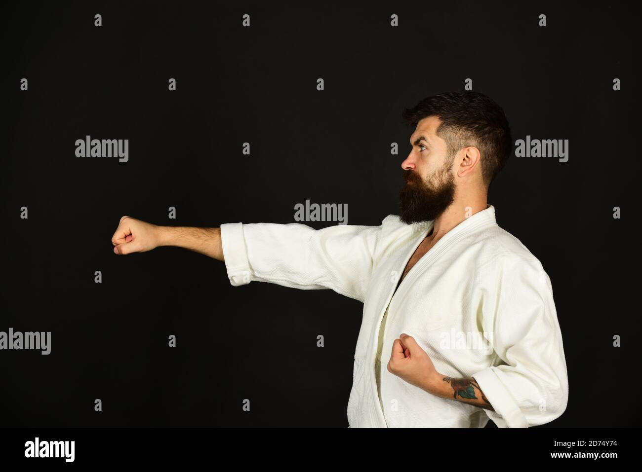 Karate man with serious face in uniform. Man with beard in white kimono ...