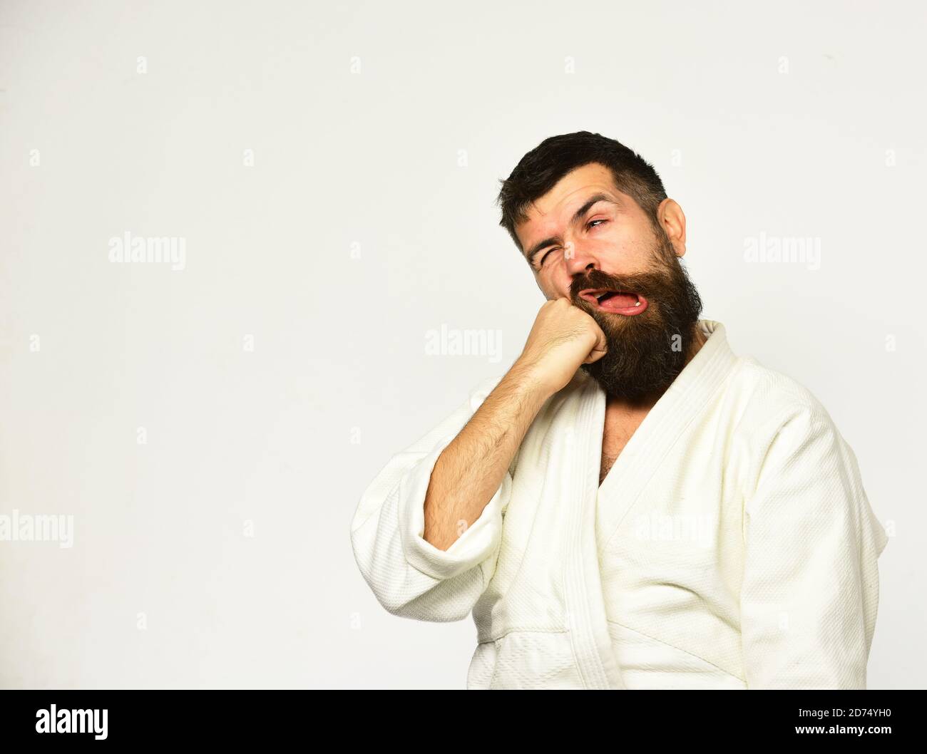 Karate man with suffering face in uniform. Japanese martial arts ...
