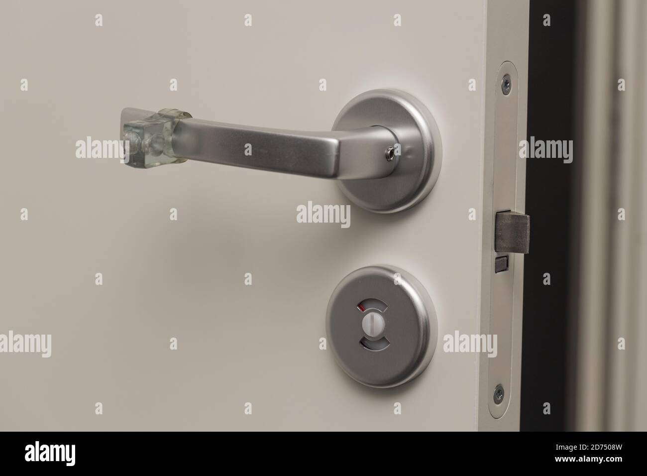 Close up view of lock and handle buffer rubber on white door. Interior ...