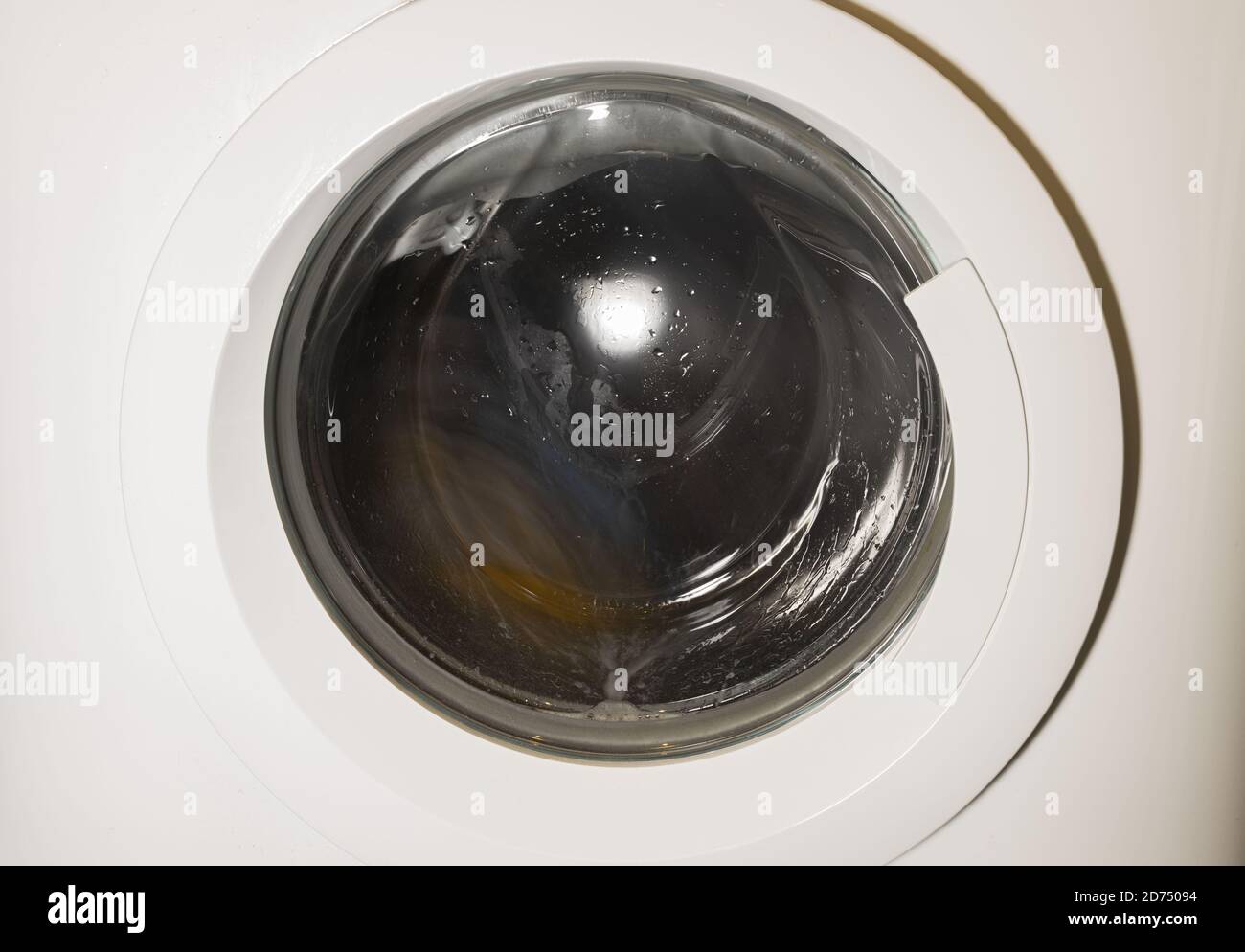 Close up view of laundry spinning in washing machine isolated. Home ...