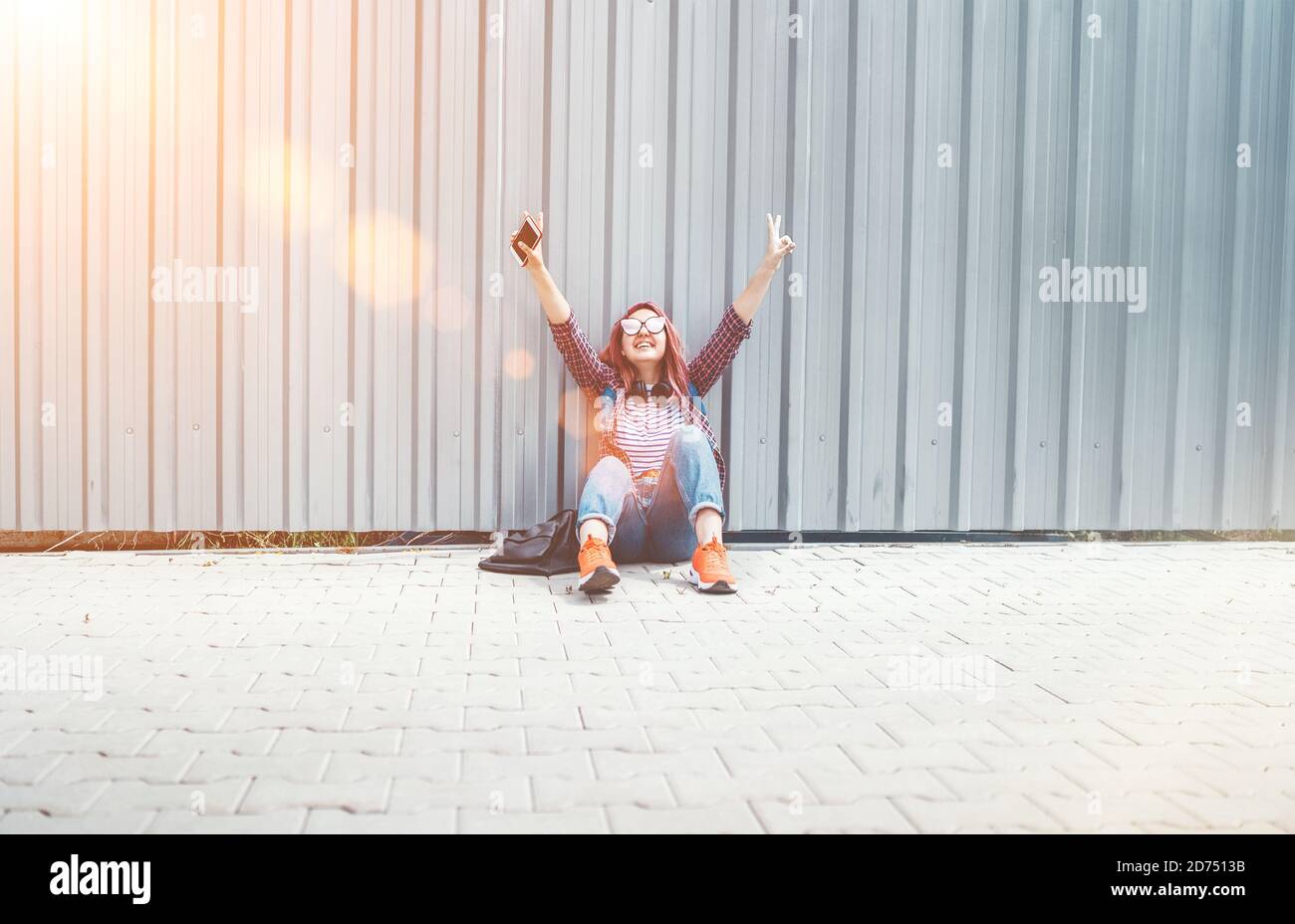 Cheerful hands rising UP Beautiful modern smiling young female teenager ...